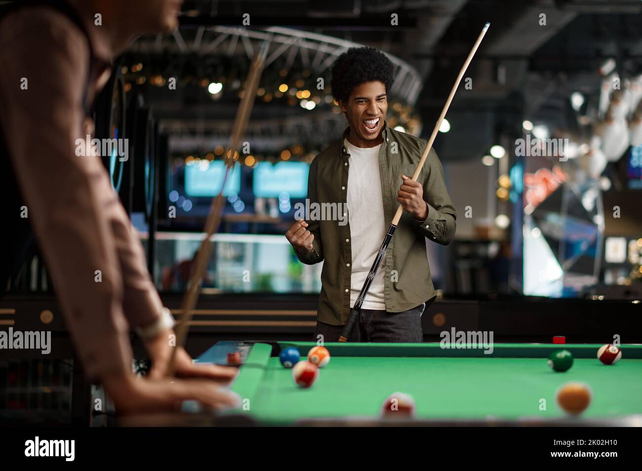 Young pool player rejoice successful hit Stock Photo - Alamy