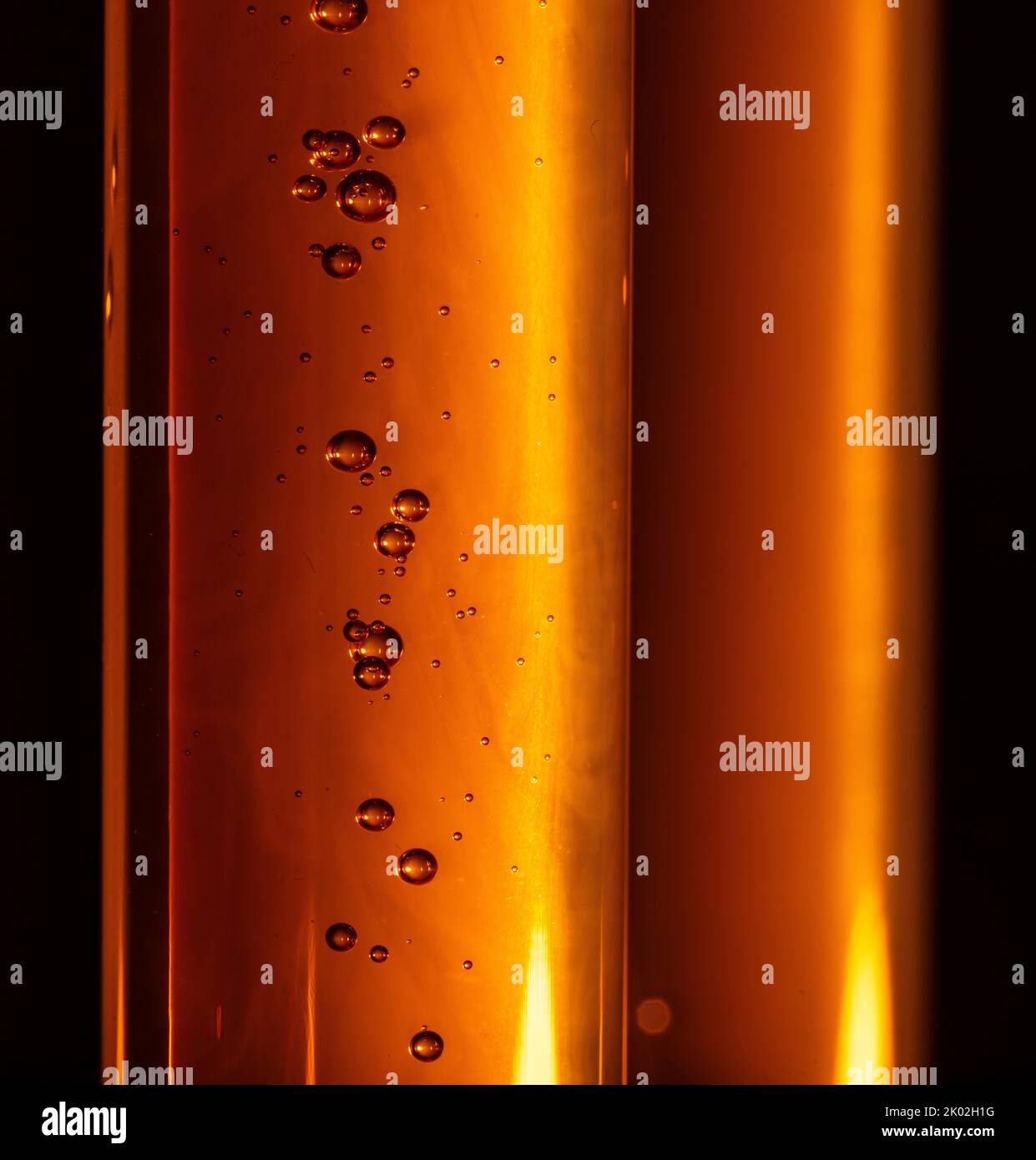 Yellow viscous liquid sunflower lecithin with bubbles in a transparent ...