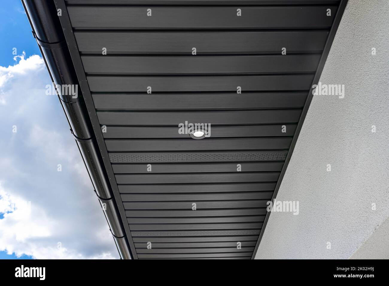 A modern graphite roof lining is attached to the trusses, visible ...