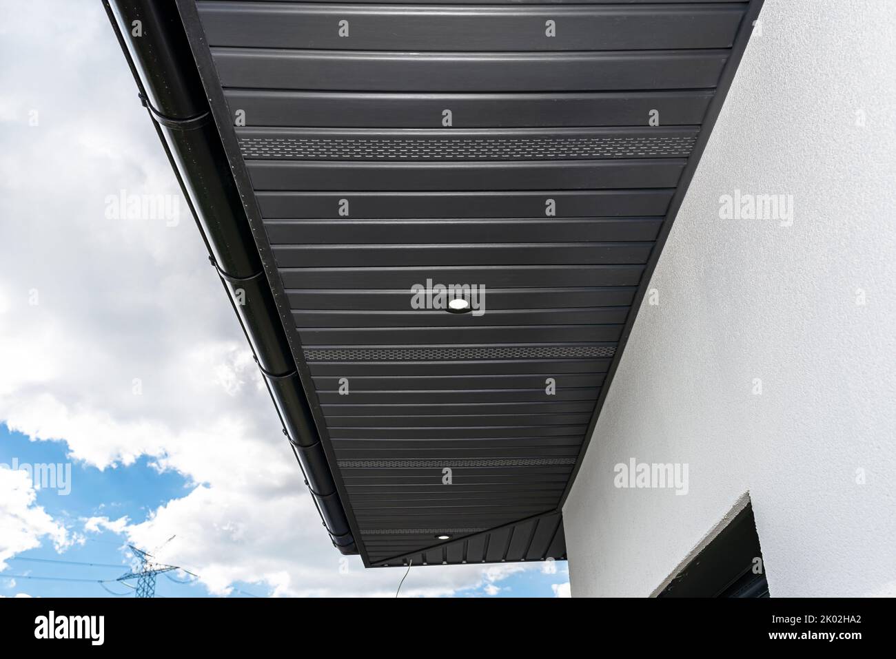 A modern graphite roof lining is attached to the trusses, visible ...