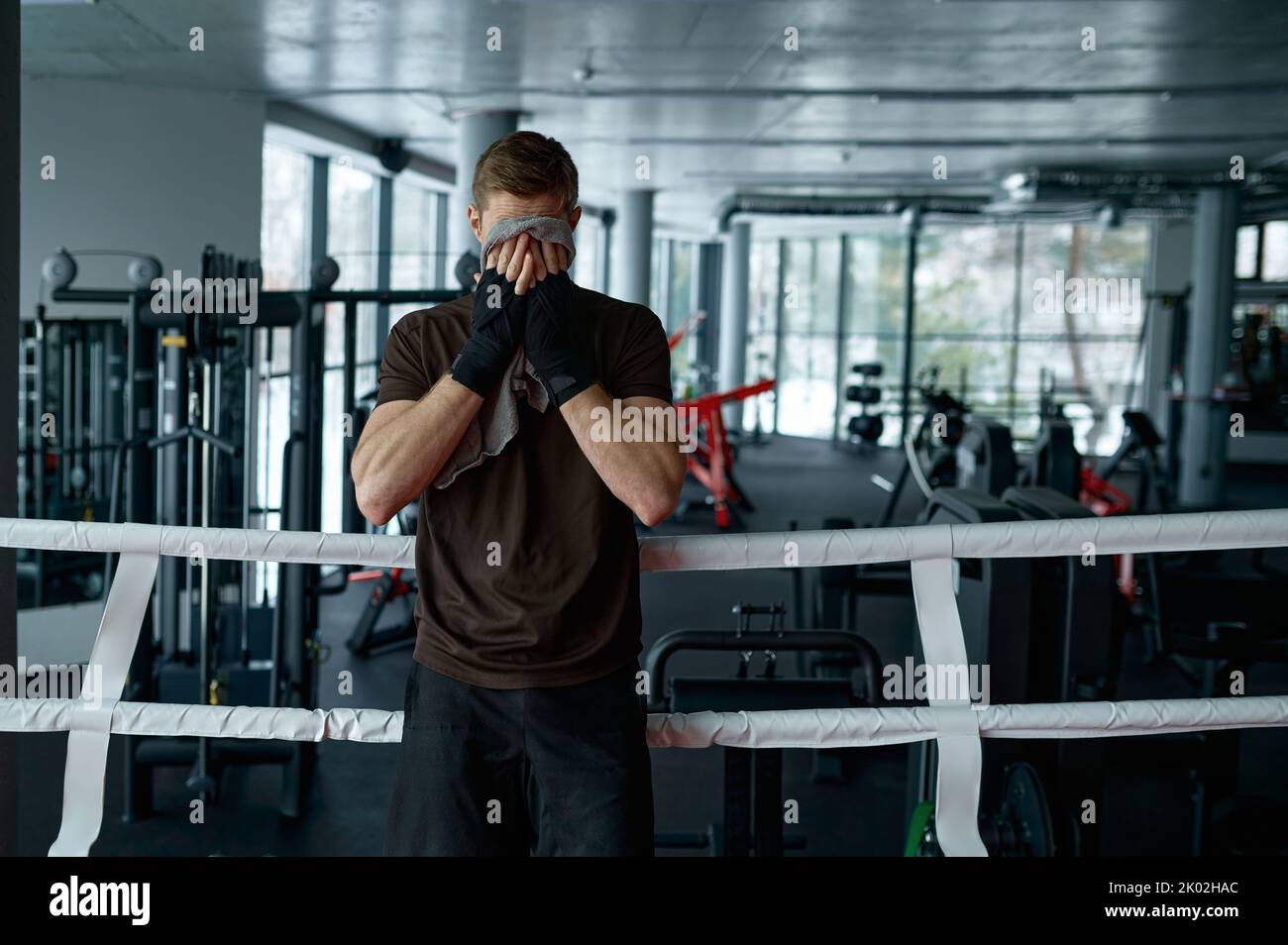Tired boxer with towel in the ring Stock Photo - Alamy
