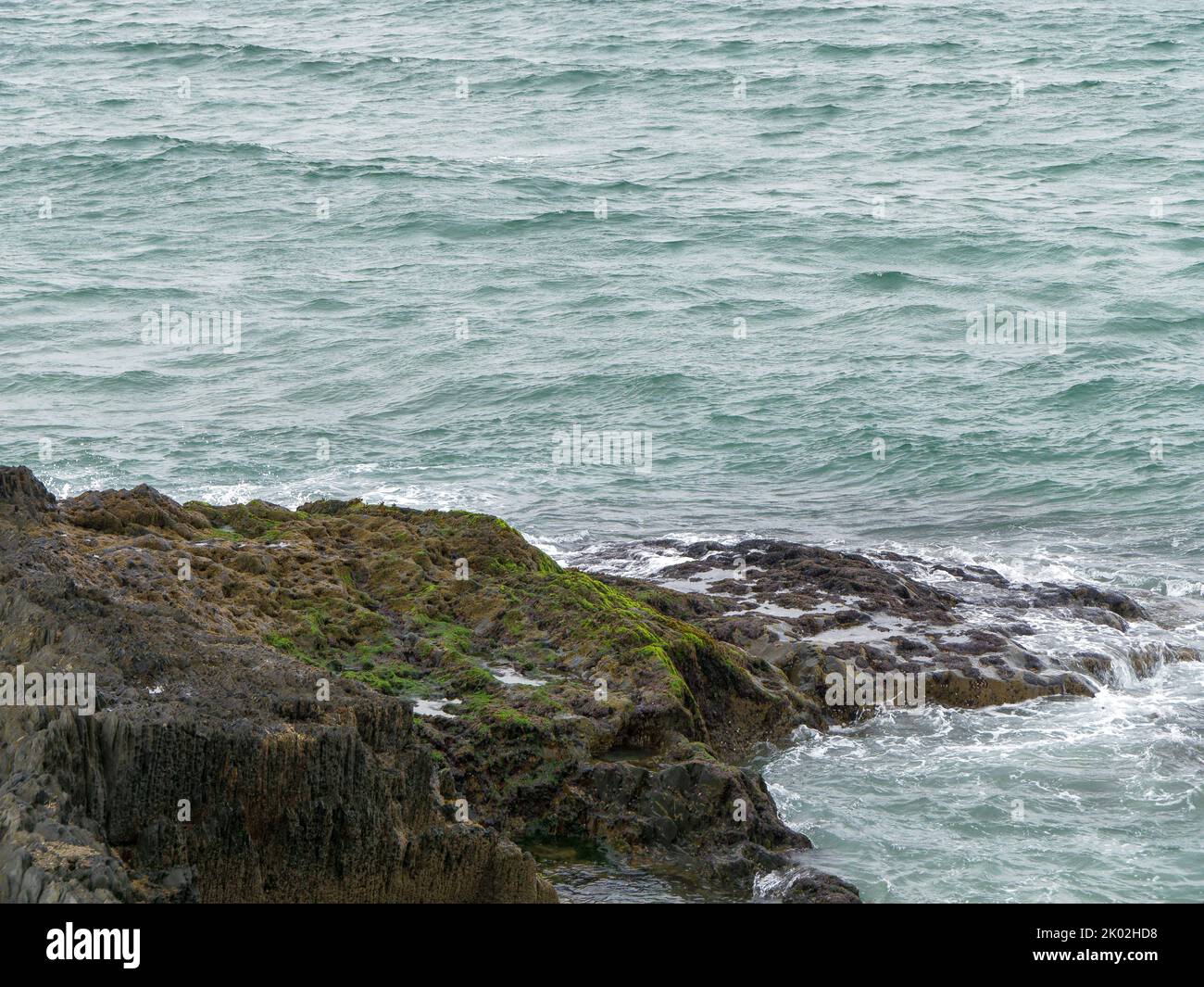Wild rock, landscape, rock formation beside body of water. Ocean waves ...