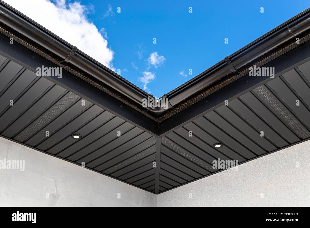 A modern graphite herringbone roof lining is attached to the trusses ...