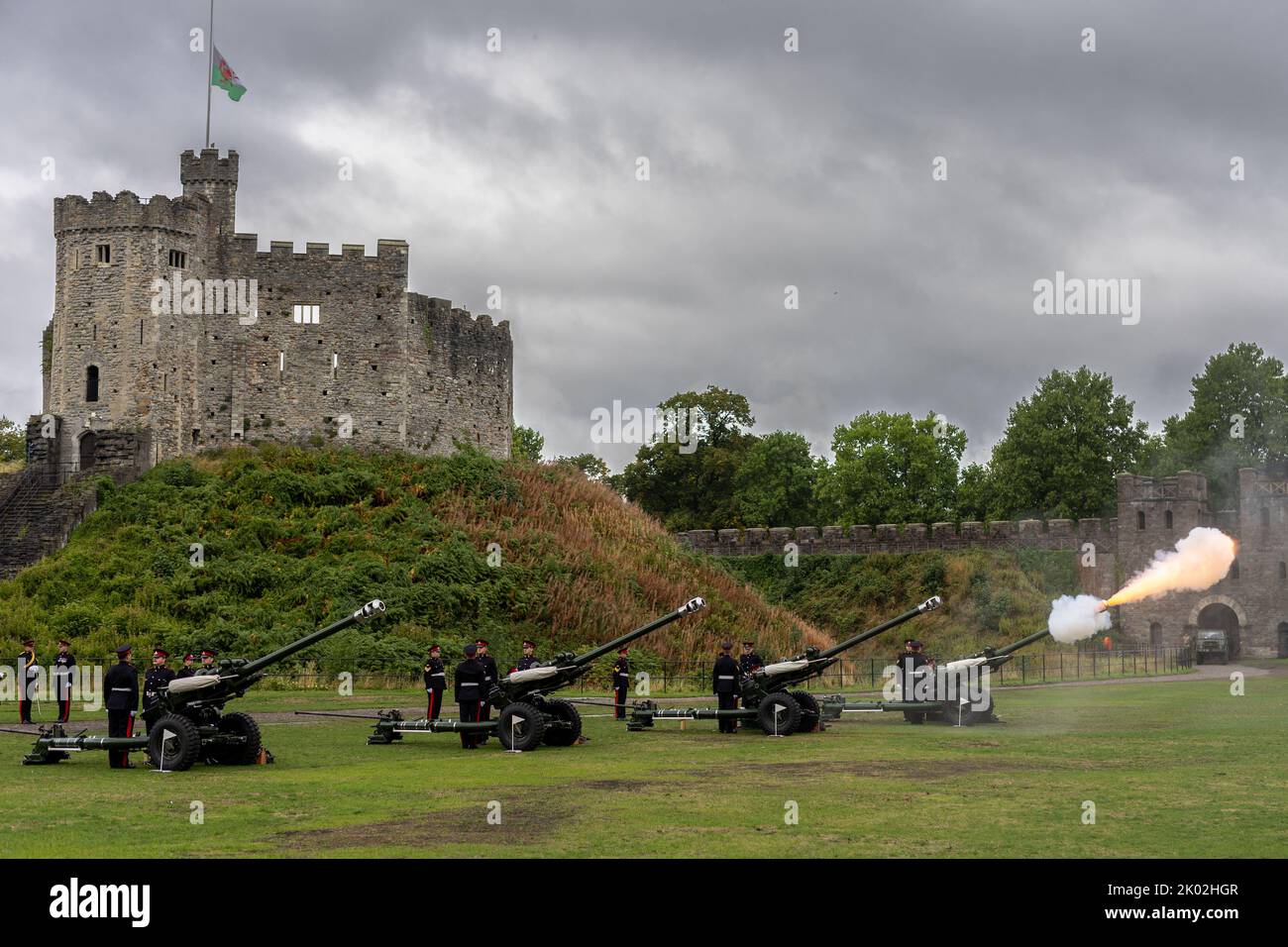 The Welsh flag at half mast as soldiers fire a 96 gun salute at Cardiff ...
