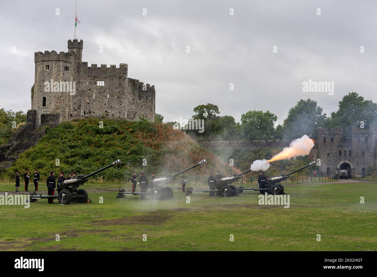 The Welsh flag at half mast as soldiers fire a 96 gun salute at Cardiff ...