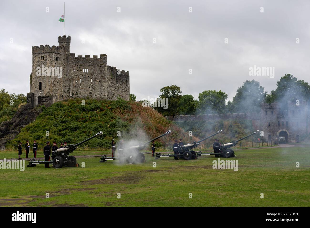 The Welsh flag at half mast as soldiers fire a 96 gun salute at Cardiff ...