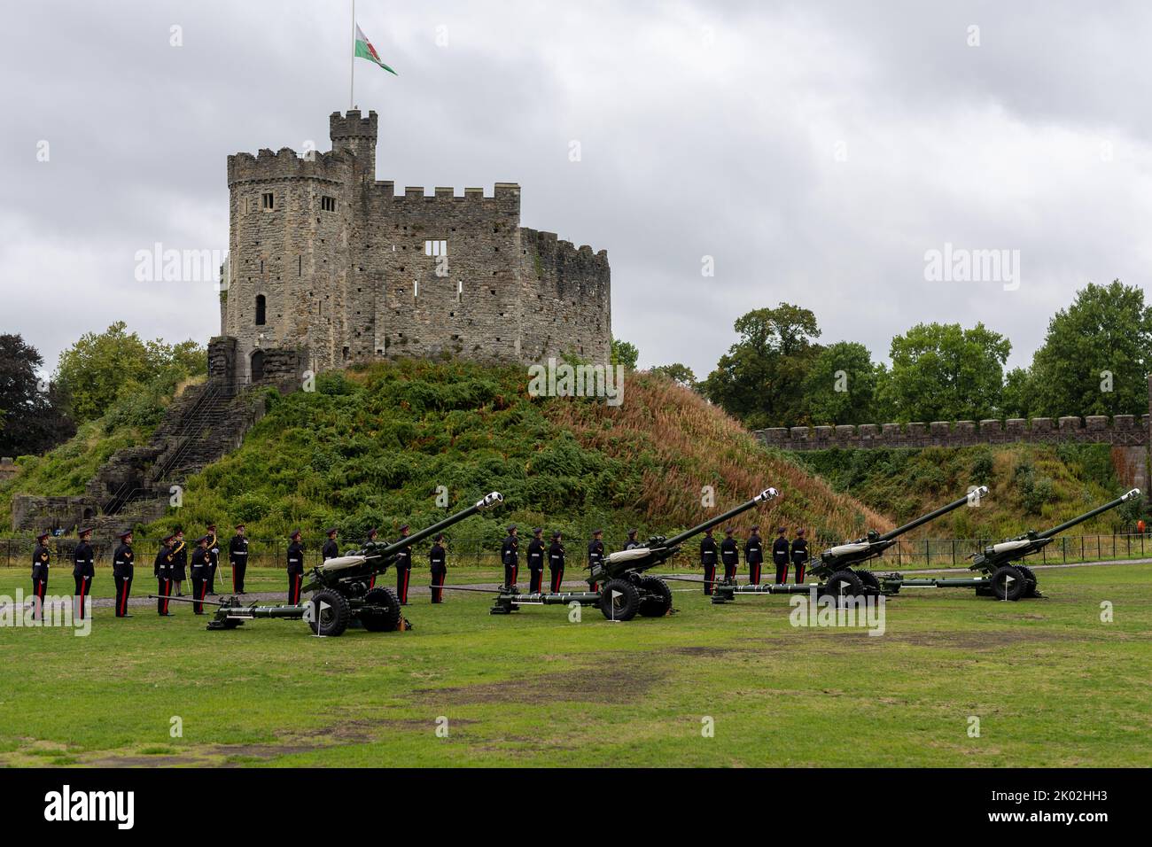 The Welsh flag at half mast as soldiers fire a 96 gun salute at Cardiff ...