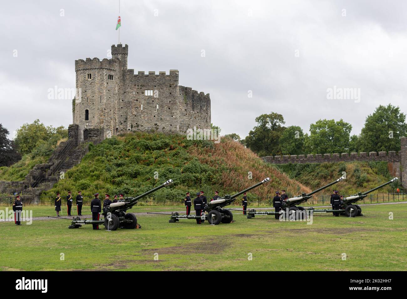 The Welsh flag at half mast as soldiers fire a 96 gun salute at Cardiff ...
