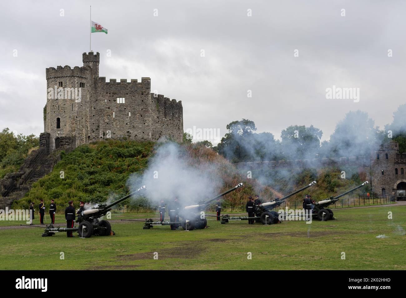 The Welsh flag at half mast as soldiers fire a 96 gun salute at Cardiff ...