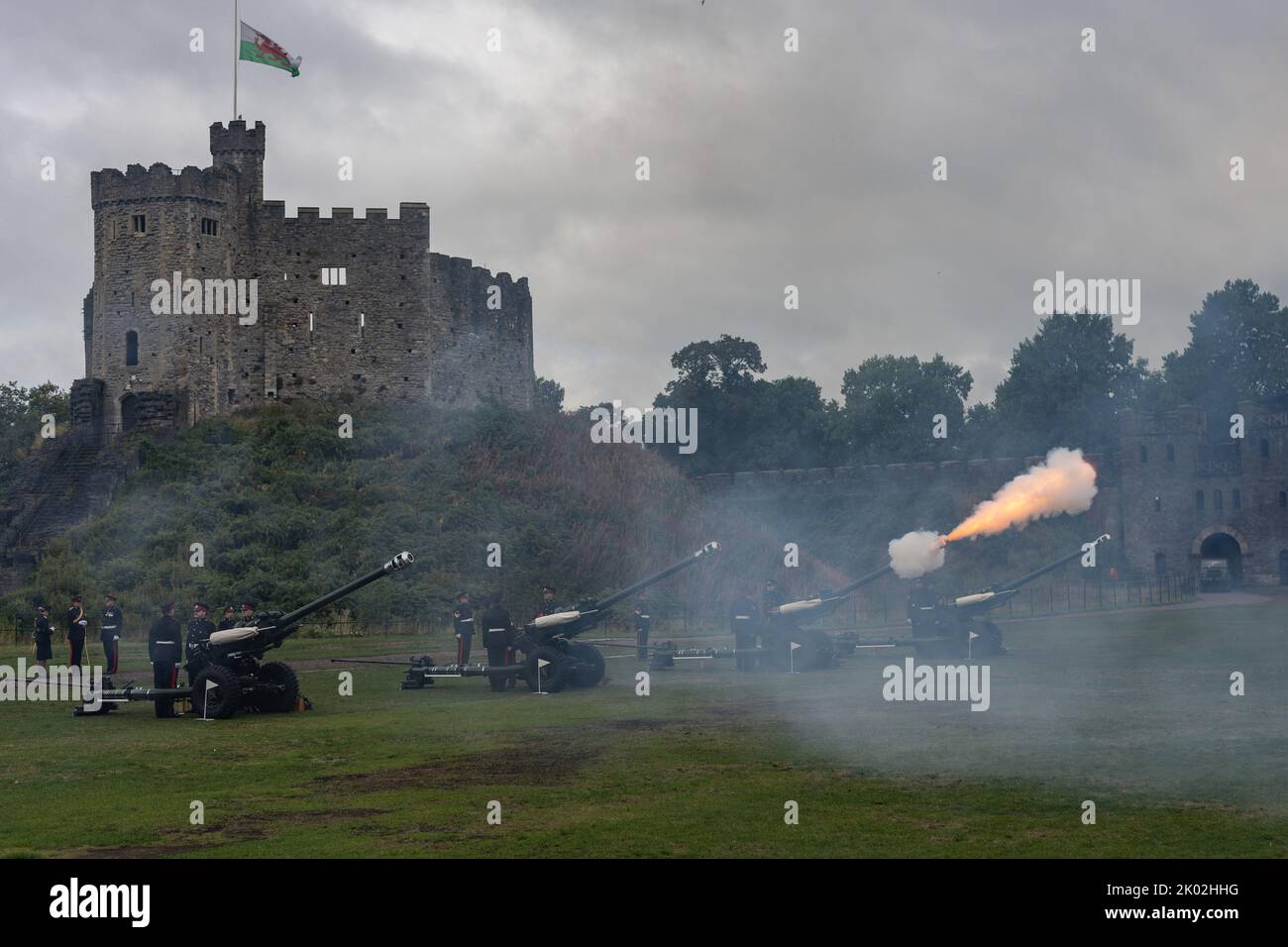 The Welsh flag at half mast as soldiers fire a 96 gun salute at Cardiff ...