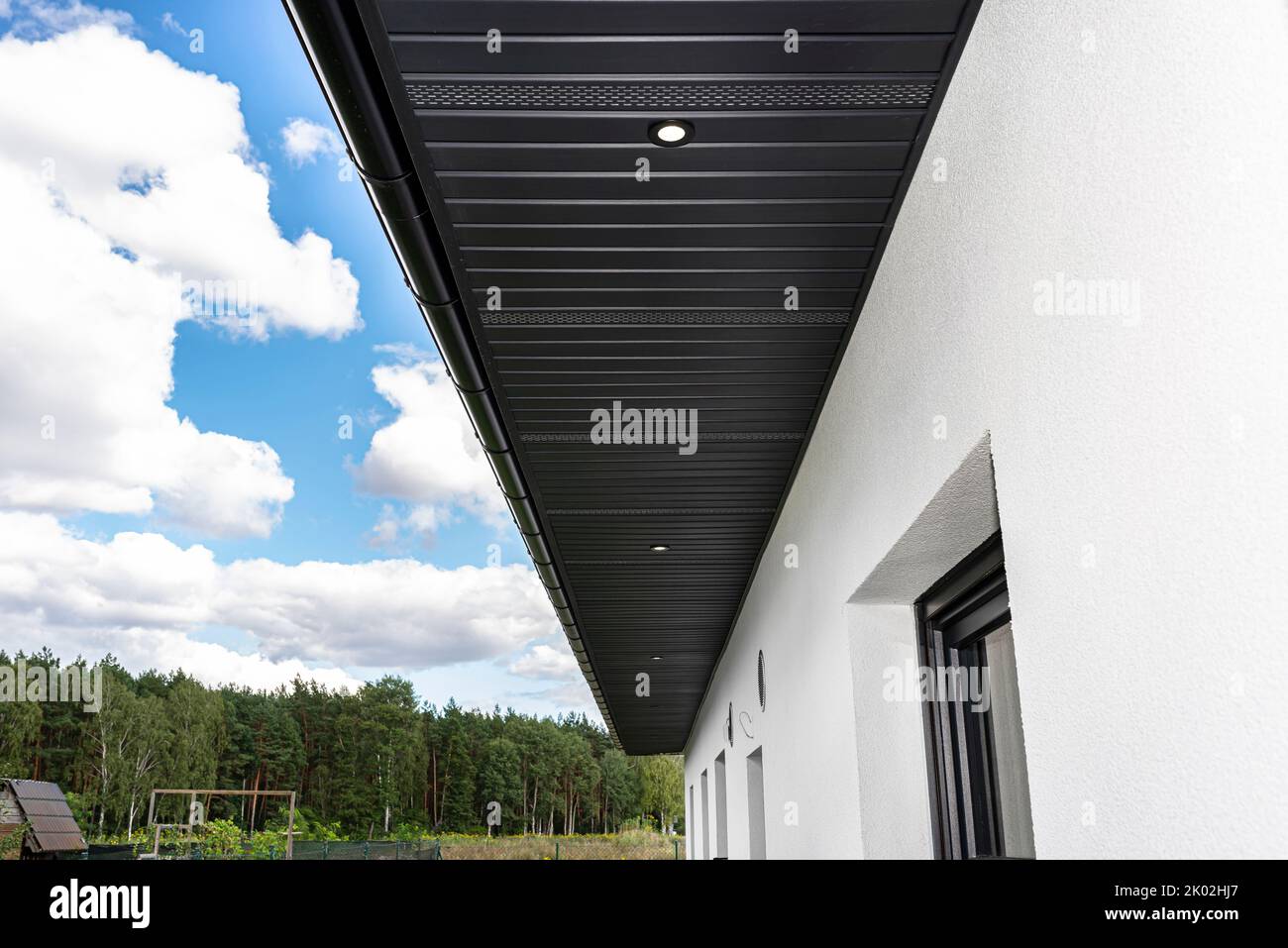 A modern graphite roof lining is attached to the trusses, visible ...