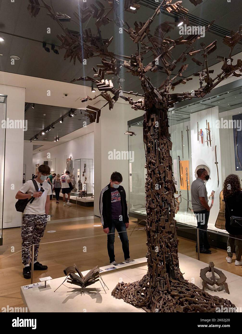 Two young students study African artefacts (reconstituted gun sculpture ...