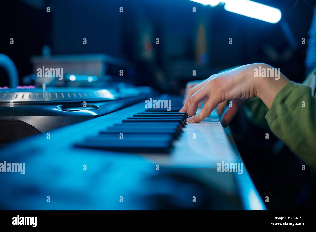 Closeup of keyboardist musician in neon light recording studio Stock ...