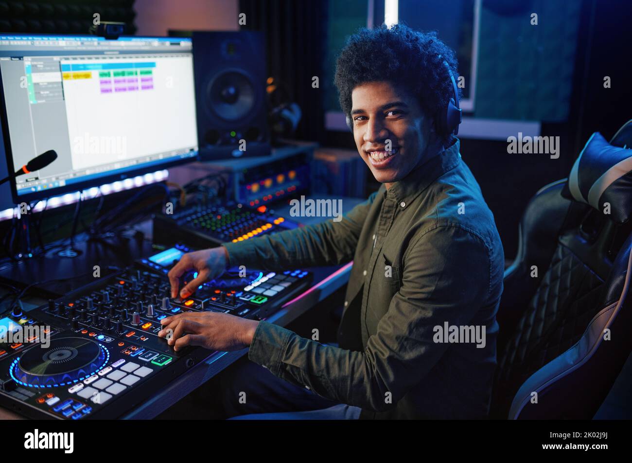 Portrait of radio host using sound mixer in studio Stock Photo - Alamy