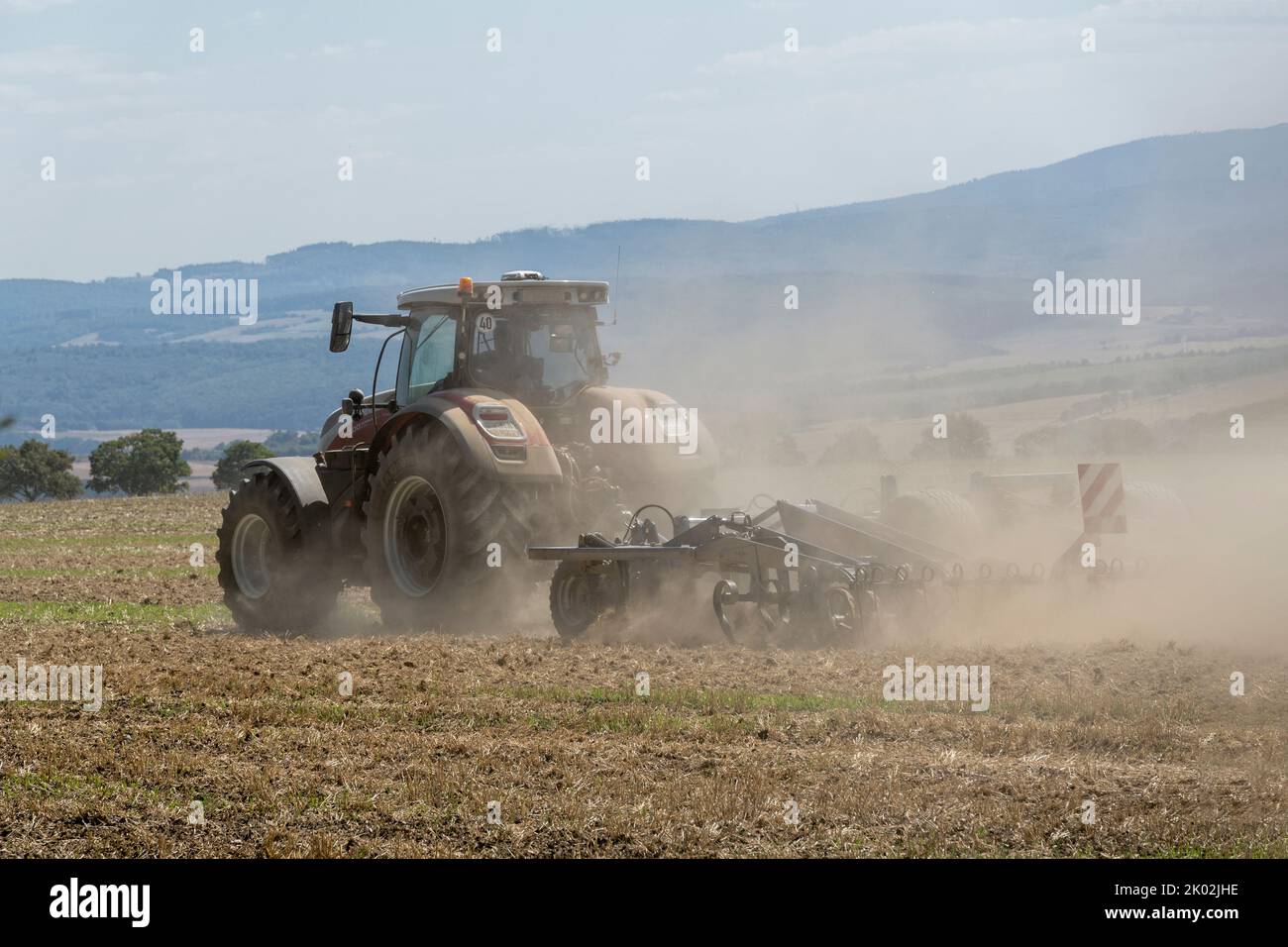 Tractor with plow on a dry field in Germany in the state of Hesse Stock ...