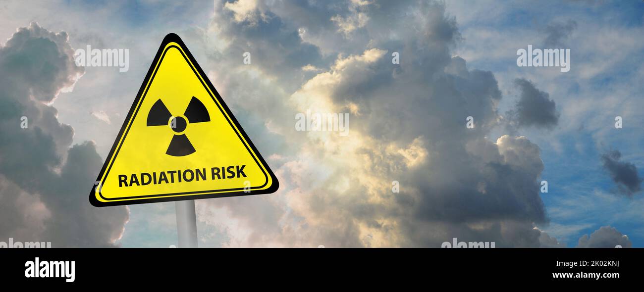 radiation risk sign on cloudy background Stock Photo - Alamy