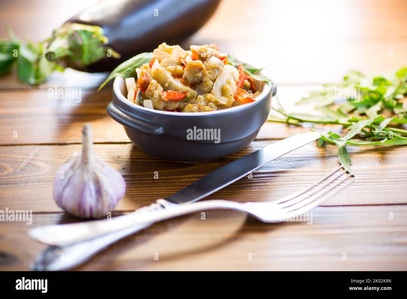 eggplant fried sauteed with other vegetables in a plate on a wooden ...