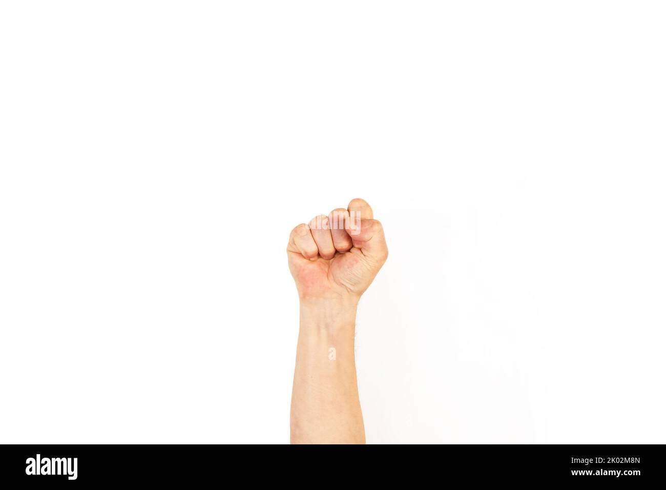 Man's arm with clenched fist on a white background with copy space ...