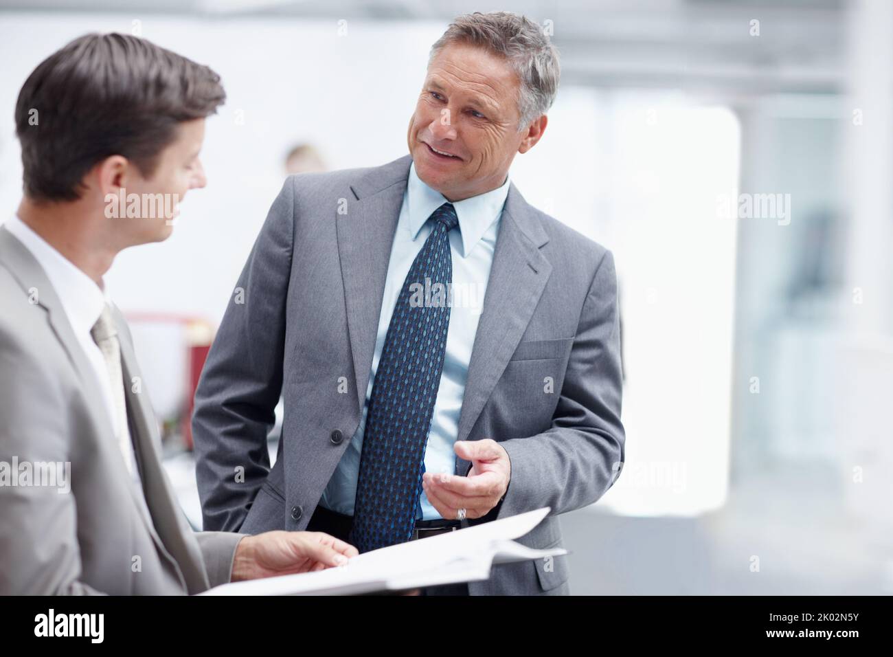 Passing his experience along. A senior executive having a friendly ...