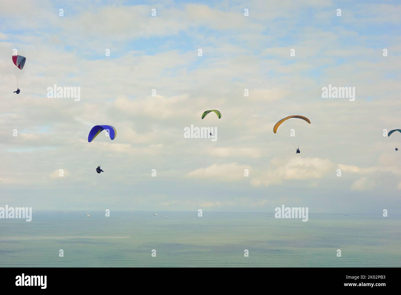 A scenic shot of people parachuting in a beautiful sky with clouds ...