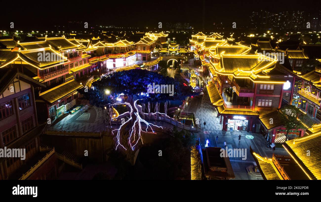 The illuminated buildings of the Impression Water street in Meishan ...