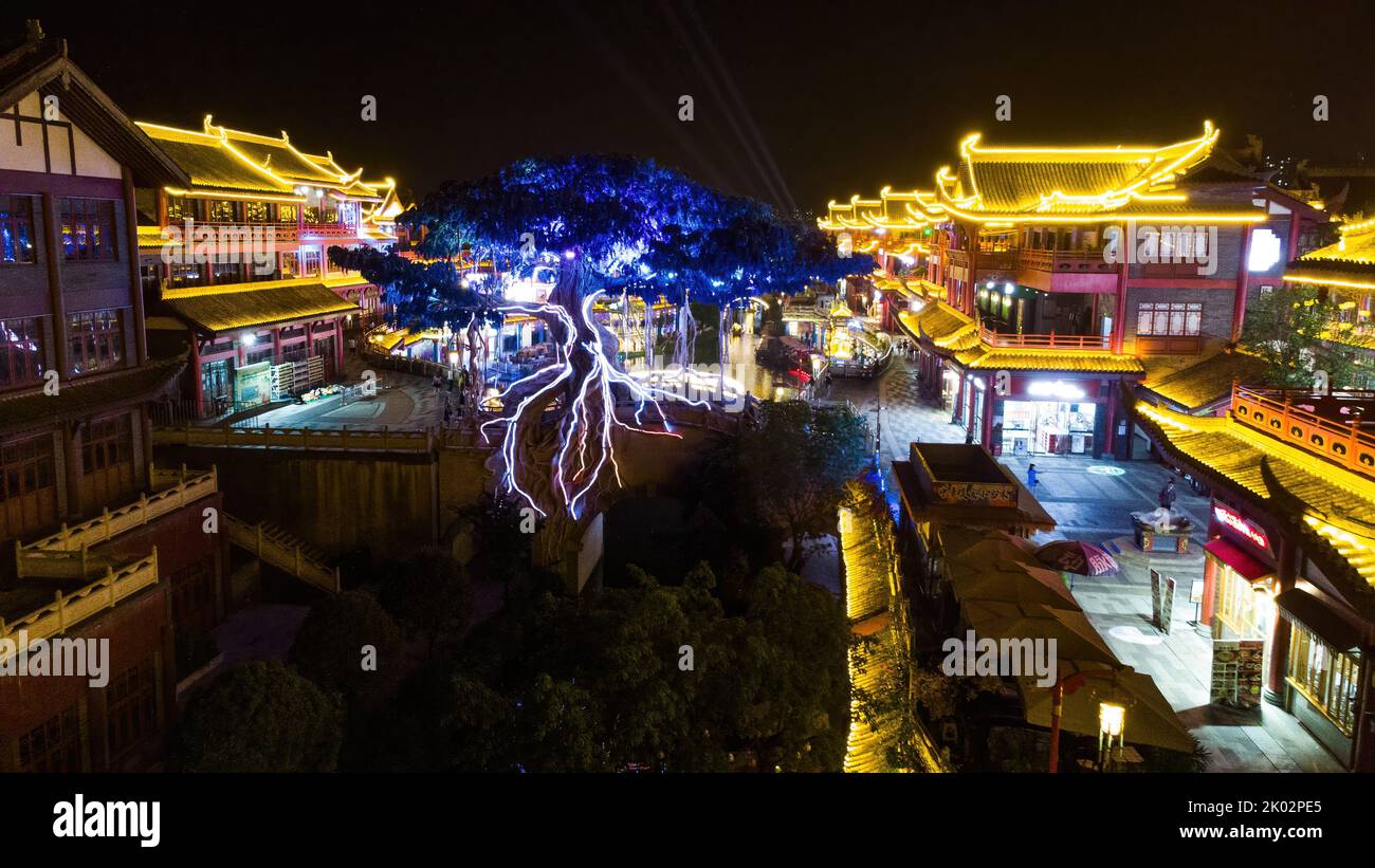 The illuminated buildings of the Impression Water street in Meishan ...