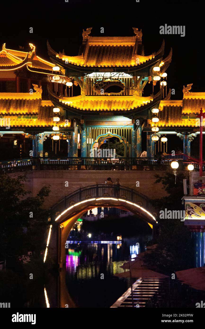 A vertical shot of the illuminated Impression Water street in Meishan ...
