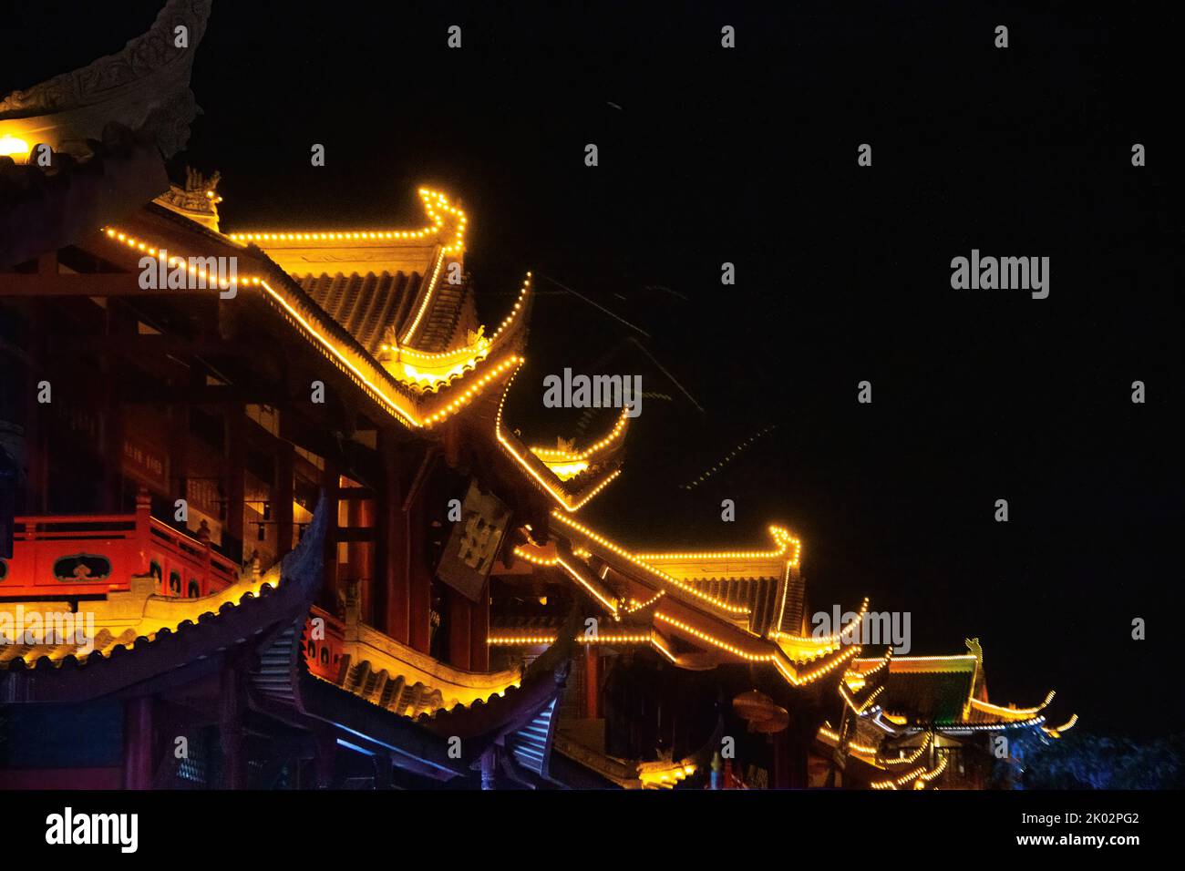 The illuminated buildings' rooftops of the Impression Water street in ...