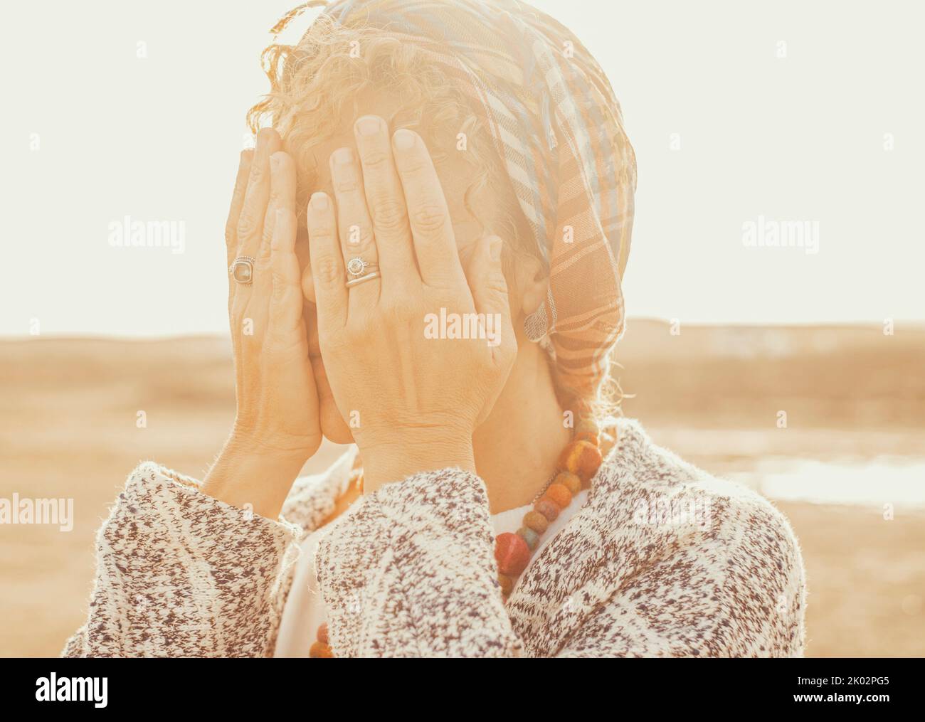 Close up portrait of female people hidden her eyes with hands to don't ...