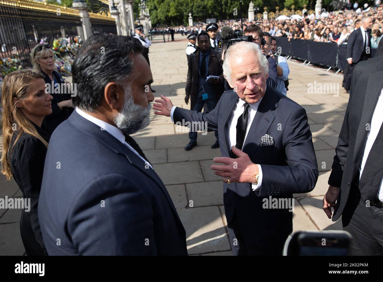 King Charles is cheered by the crowd as they walk into Buckingham ...