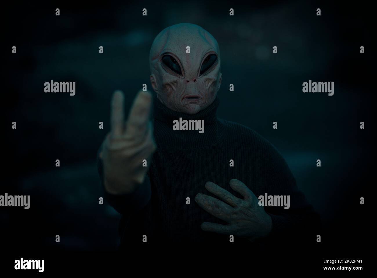 Dark porrait of alien extraterrestrial doing peace and victiry gesture ...