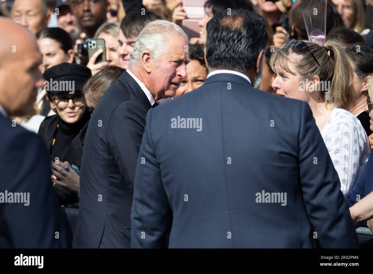 King Charles is cheered by the crowd as they walk into Buckingham ...