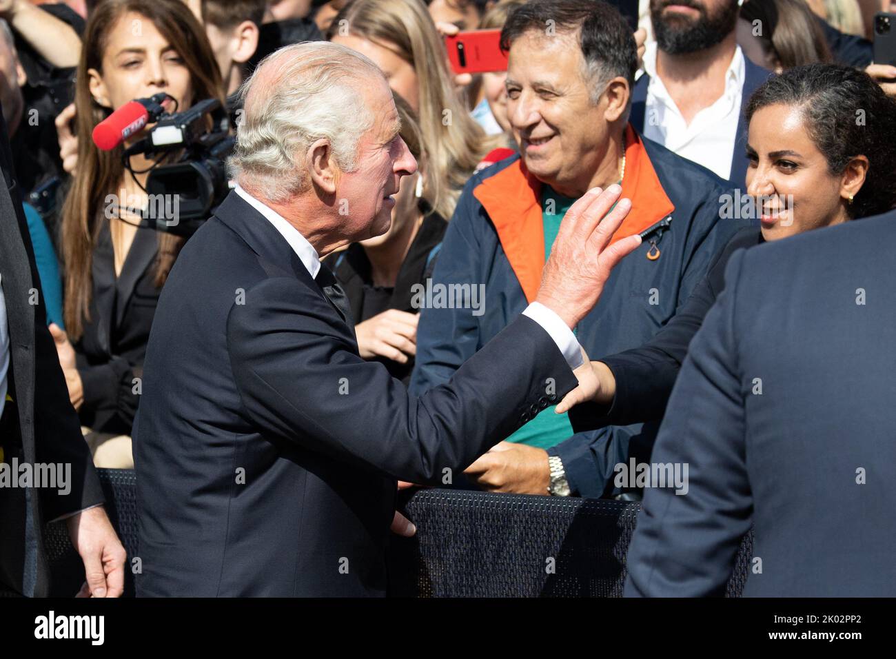 King Charles is cheered by the crowd as they walk into Buckingham ...