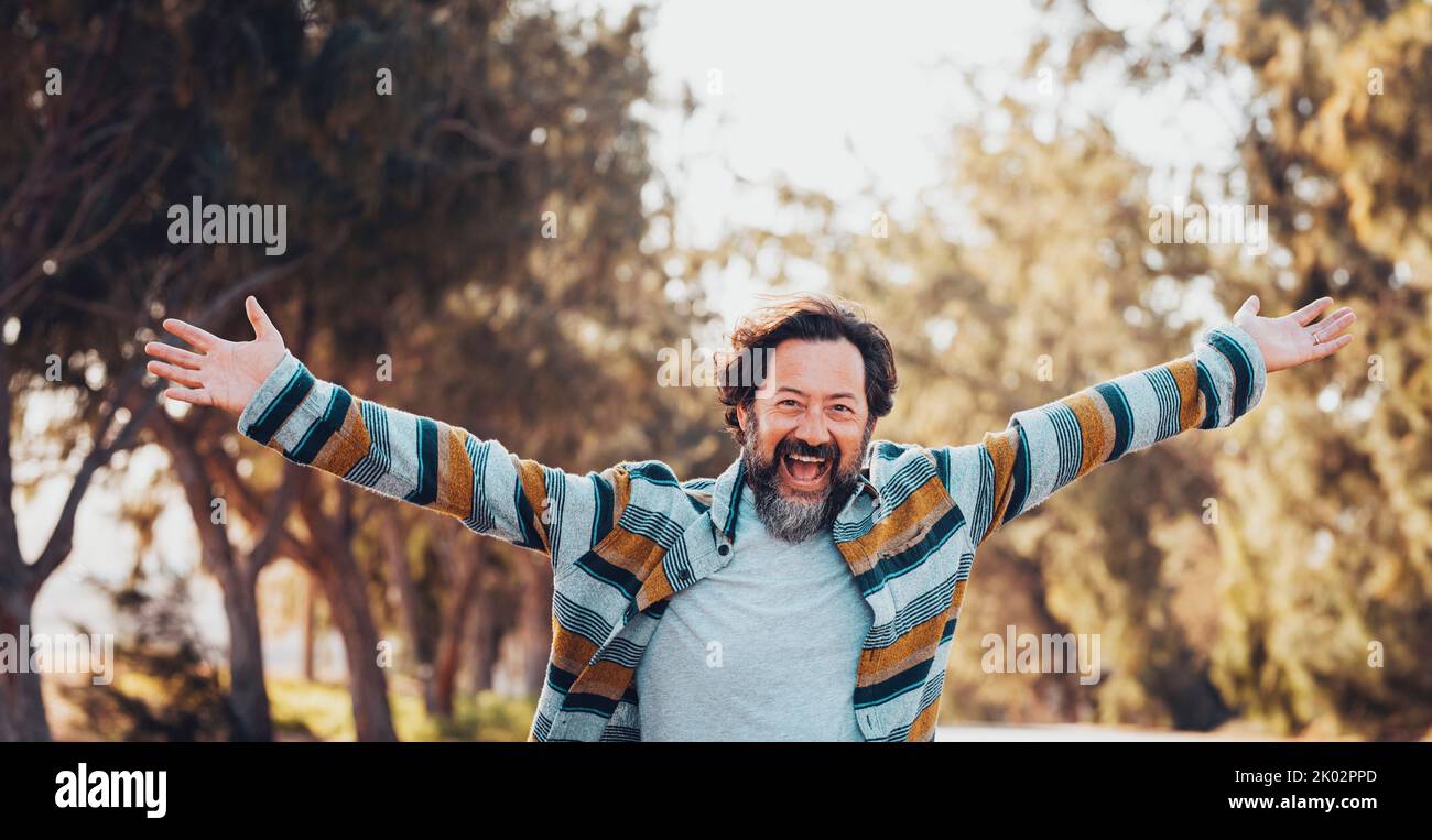 Crazy overjoyed adult man with arms outstretched smile and laugh alone ...