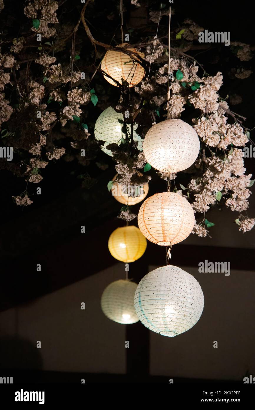 A vertical shot of the illuminated lamps of the Impression Water street ...