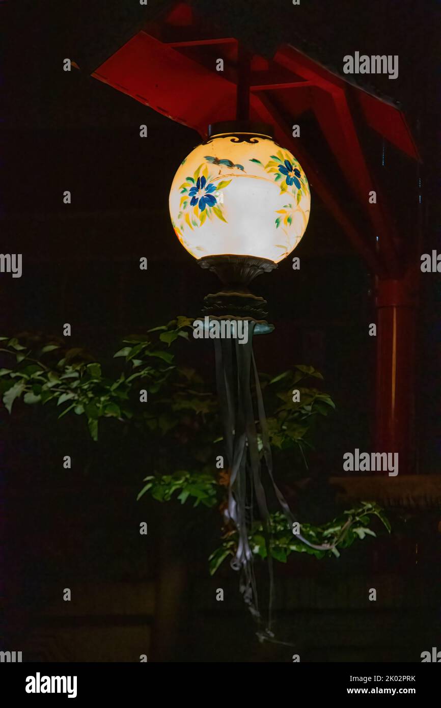 A vertical shot of an illuminated lamp of the Impression Water street ...