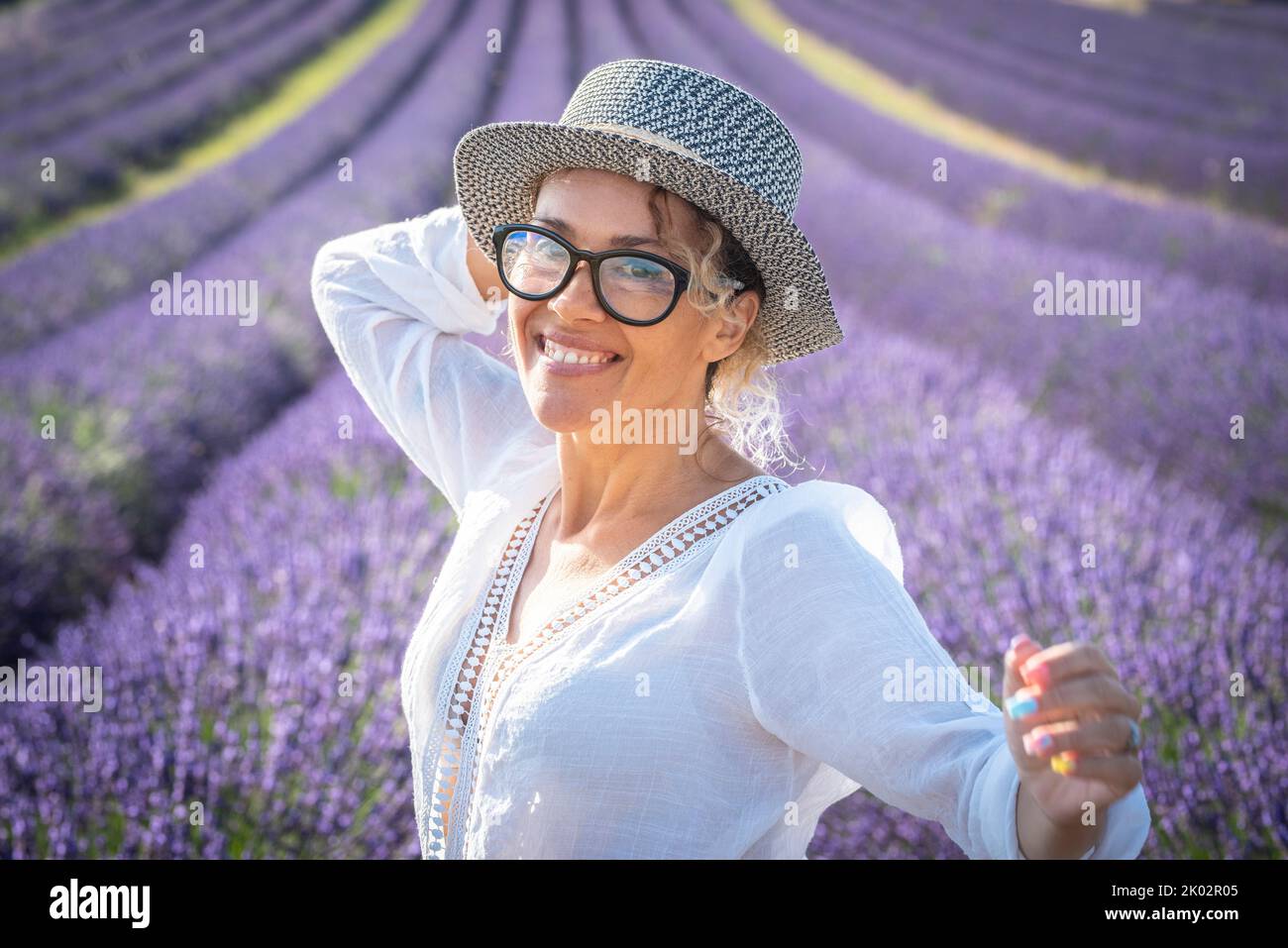 Portrait of happy young woman smiling and enjoying leisure outdoor ...