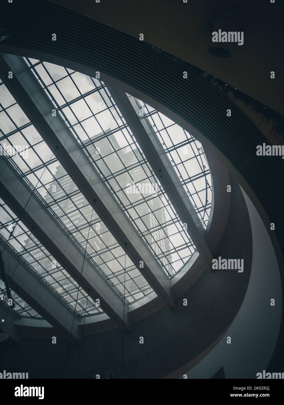 A vertical low angle shot of a beautiful circle ceiling with a glass ...