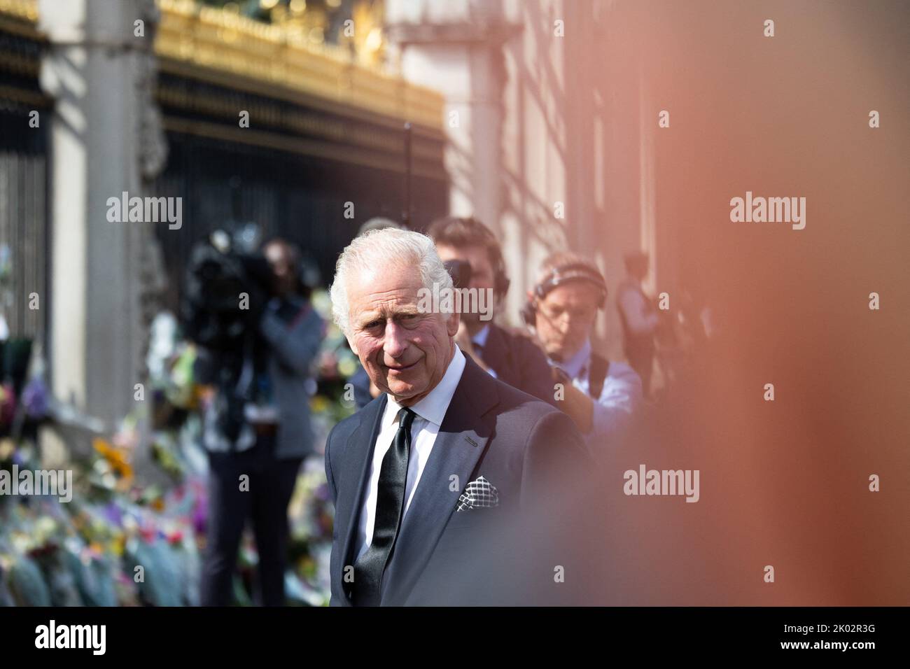 King Charles is cheered by the crowd as they walk into Buckingham ...