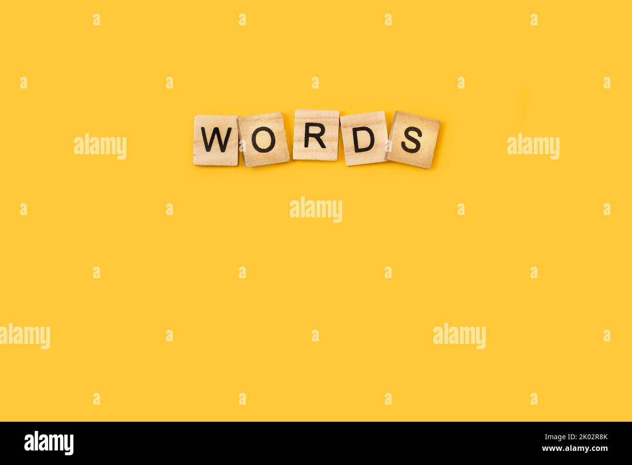 Words write with wooden letter cubes on an yellow background Stock ...