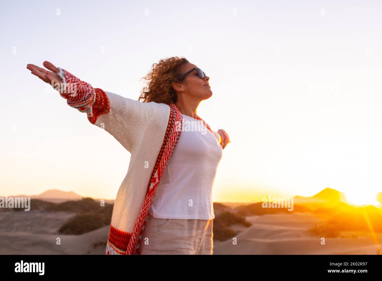 Inner balance and happiness concept with young woman opening arms and ...