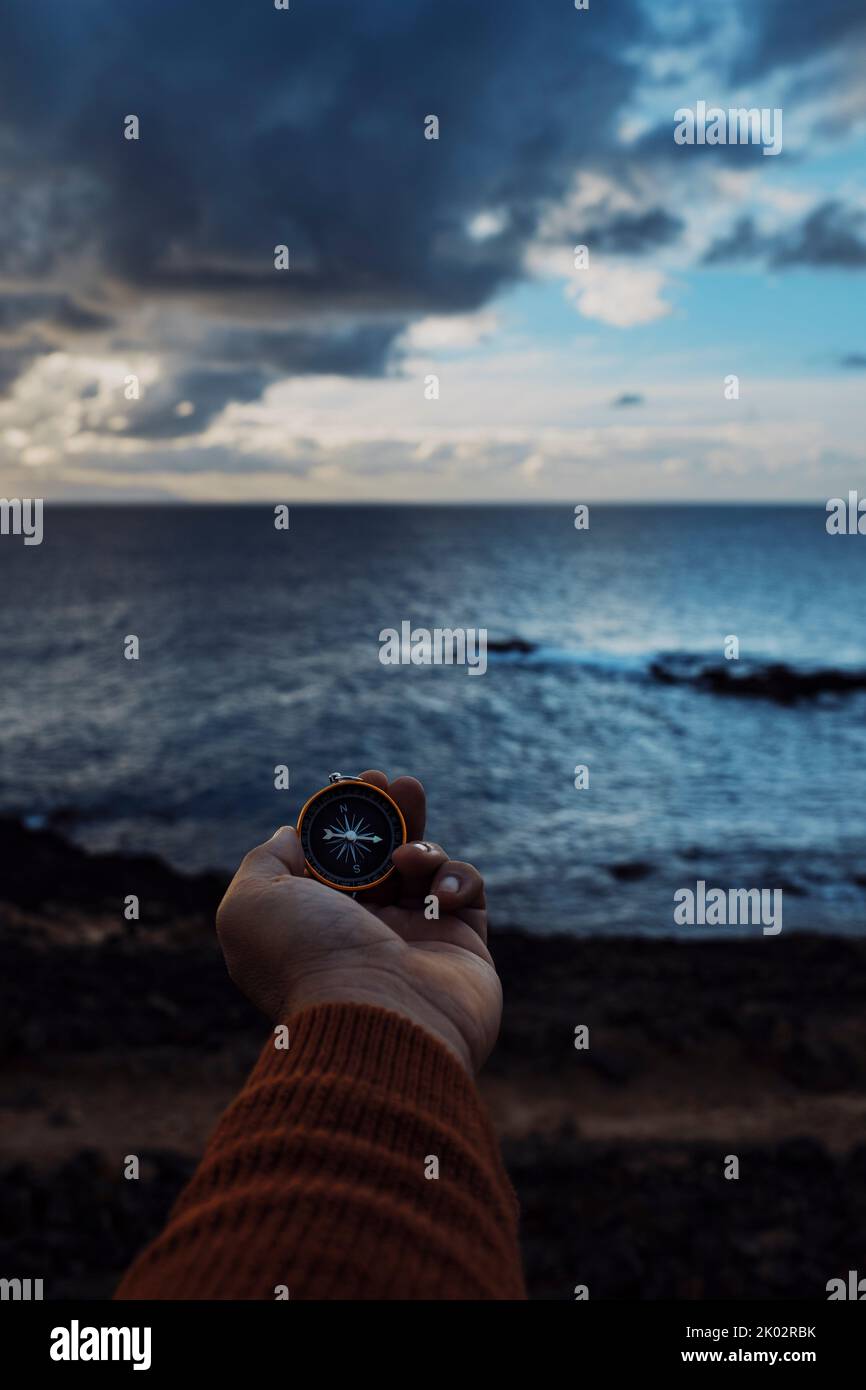 Point of view of man holding navigator compass magnetic. Lost direction ...