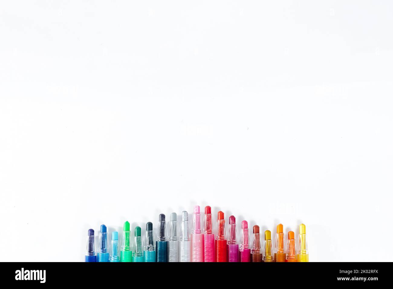 A closeup of colorful markers on a white background with copy space ...