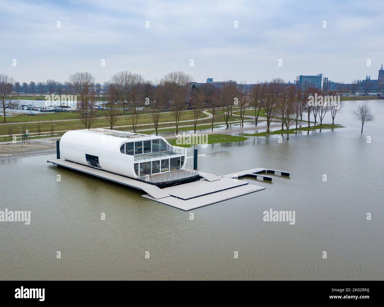 An aerial view of flooded lake with a modern house near the city of ...