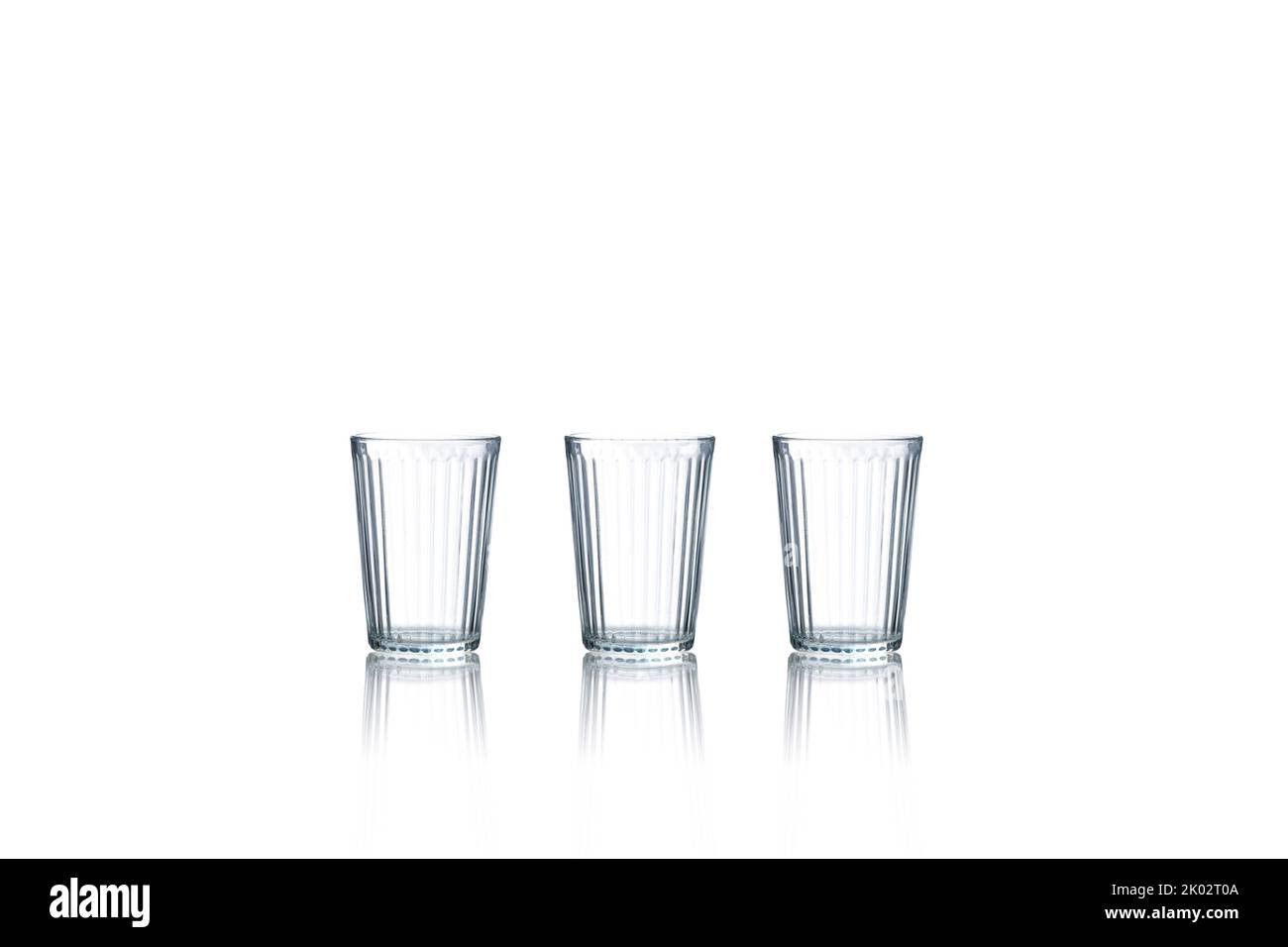 The three empty cups made of glass isolated on a white background Stock ...