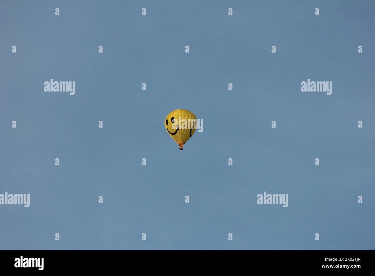 A smiley face hot air balloon in the sky Stock Photo - Alamy