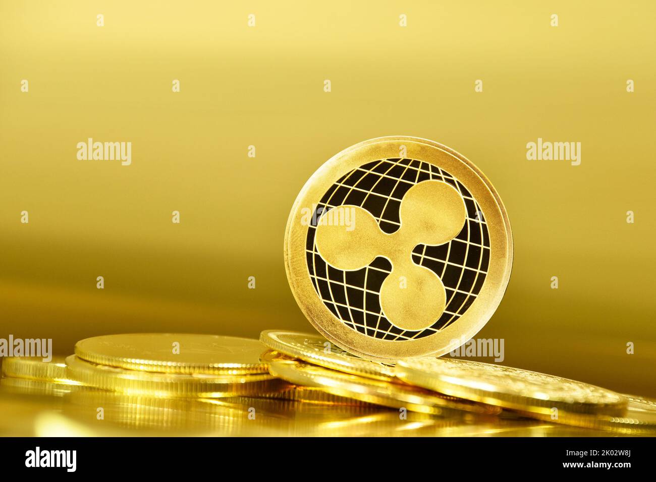 The ripple coin on a golden background. Cryptocurrency concept Stock ...