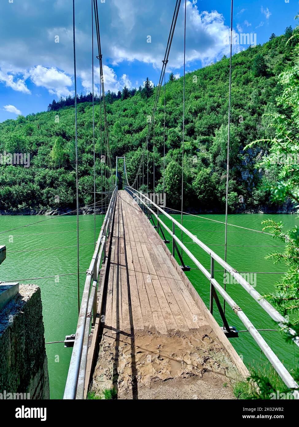A vertical shot of a small wooden pedestrian bridge over a river Stock ...