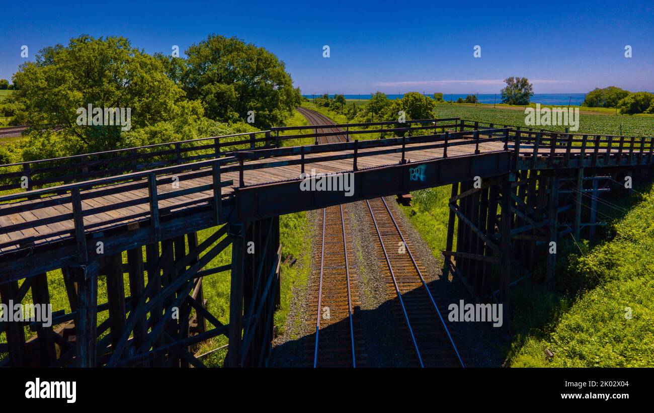 A rail bridge overpass over the train railway Stock Photo - Alamy