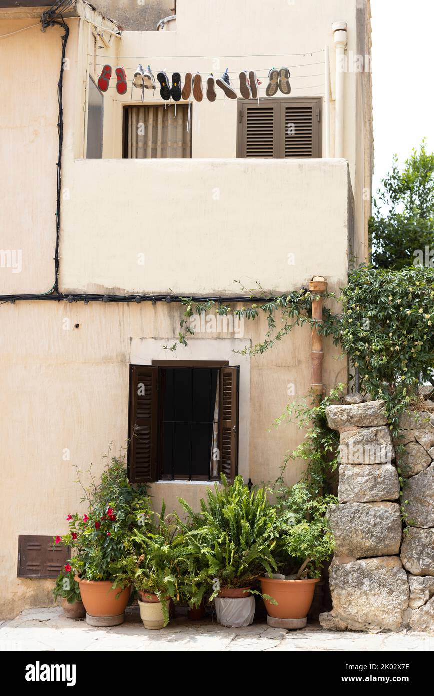 Shoes on the clothesline on the balcony of mediterranean house hi-res ...